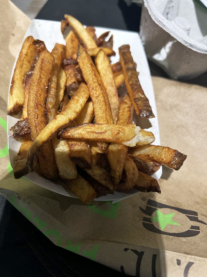 Hand-cut fries that prove some things in life are worth waiting for, especially with that perfect seasoning.