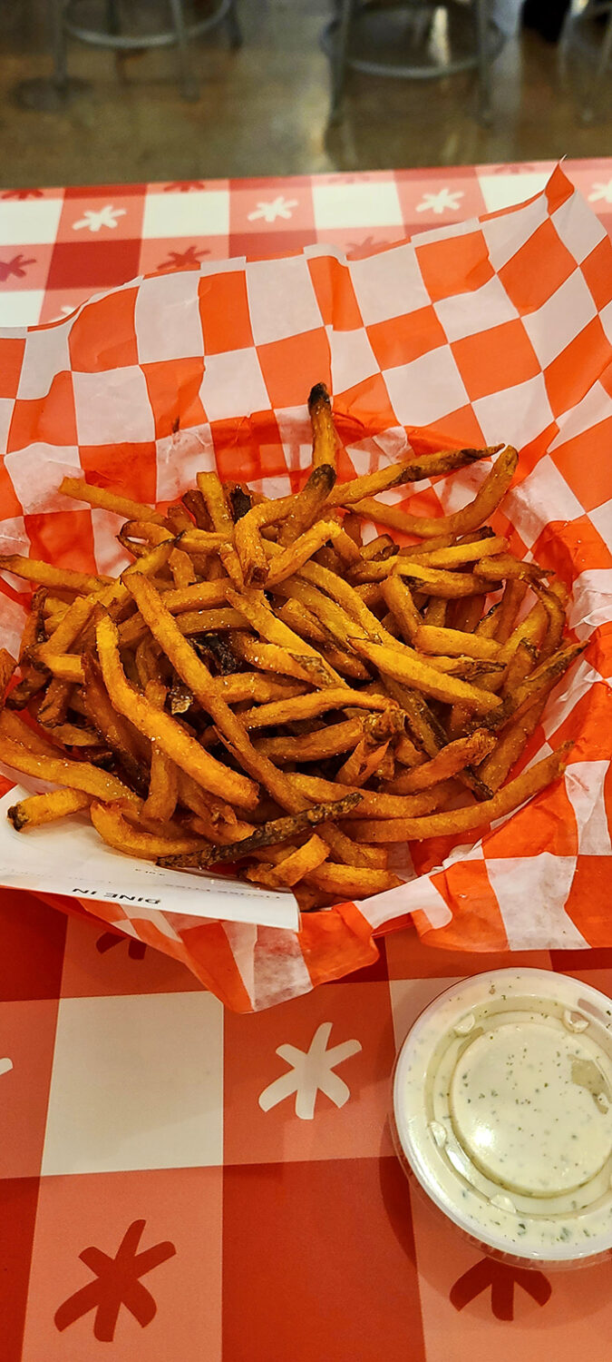 Crispy, hand-cut fries that deserve their own fan club. That little cup of ranch isn't just a condiment&mdash;it's a cooling lifeline after the chicken heat.