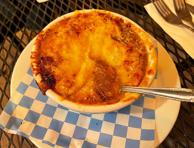 Bubbling cheese creates a magnificent crust on this French onion soup, a warm hug in a bowl that's worth every delicious, stringy bite.