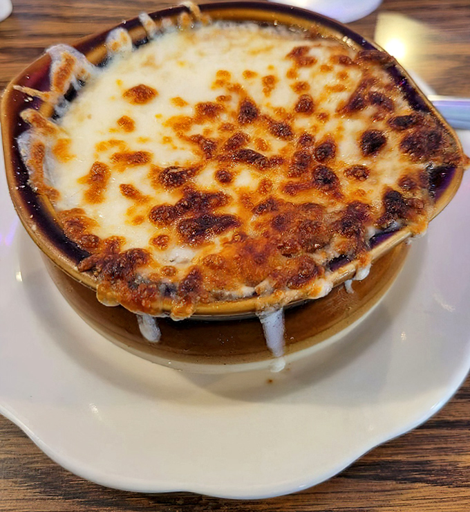 Bubbling cheese forms a golden canopy over this French onion soup—the kind of comfort that makes you forget about fancy restaurants and $18 appetizers.