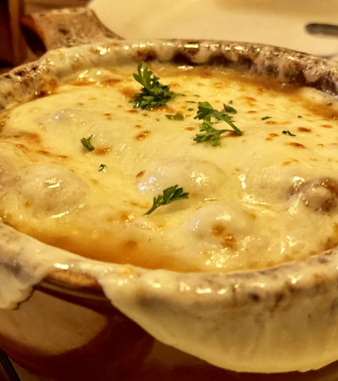French onion soup that's had a proper education&mdash;a bubbling masterclass in patience where cheese stretches like your uncle's fishing stories.