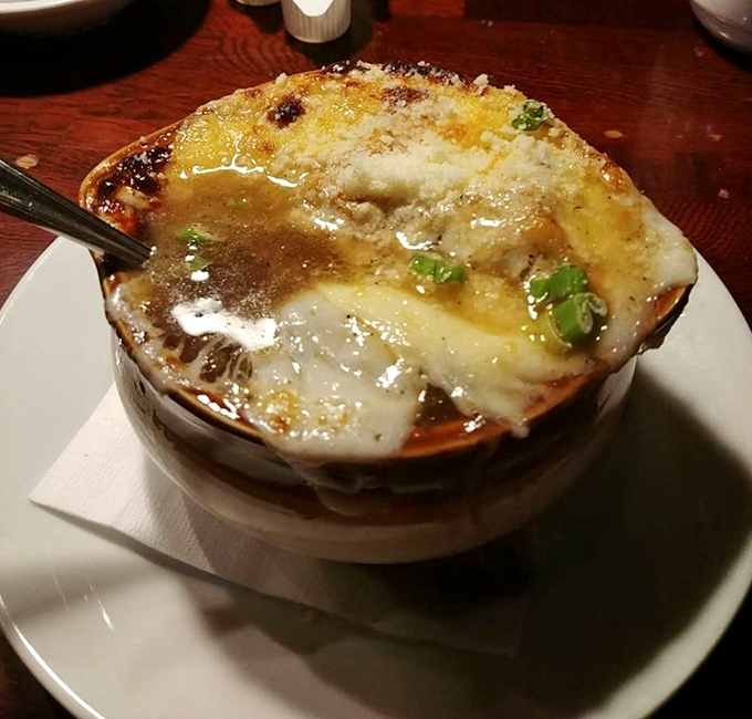 This isn't just French onion soup&mdash;it's a cheese-crowned masterpiece of savory comfort. The spoon-breaking crust signals greatness beneath.