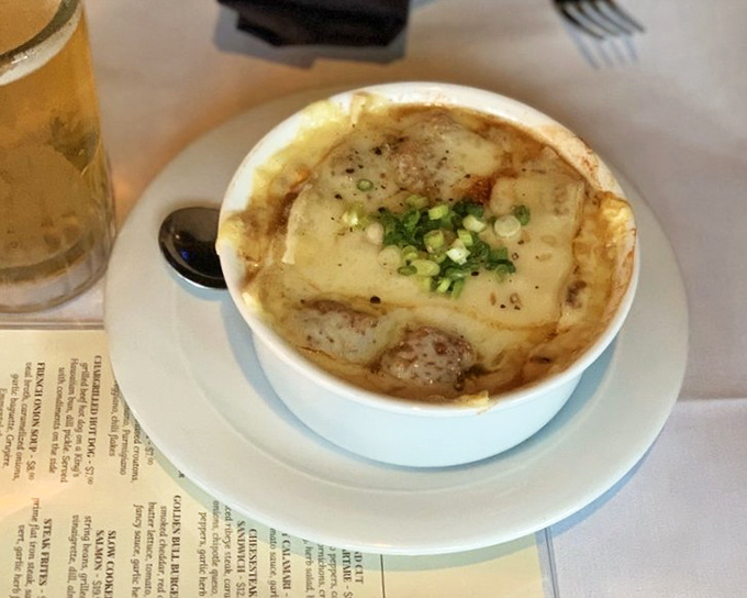 French onion soup that's worth the inevitable cheese pull photo-op. Caramelized onions swimming in rich veal broth beneath a molten cheese canopy.