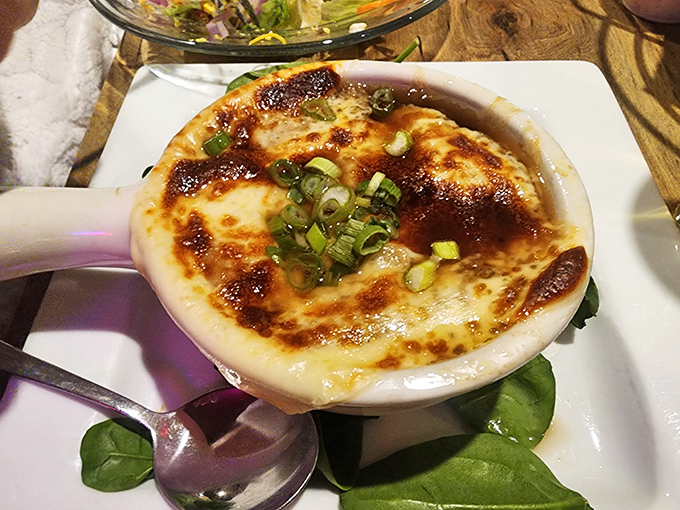 Bubbling cheese blanket hides French onion soup that would make Julia Child weep with joy.