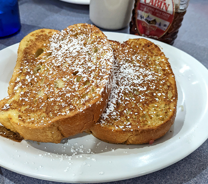 French toast dusted with powdered sugar like edible snow &ndash; thick, golden, and absolutely worth the inevitable food coma.