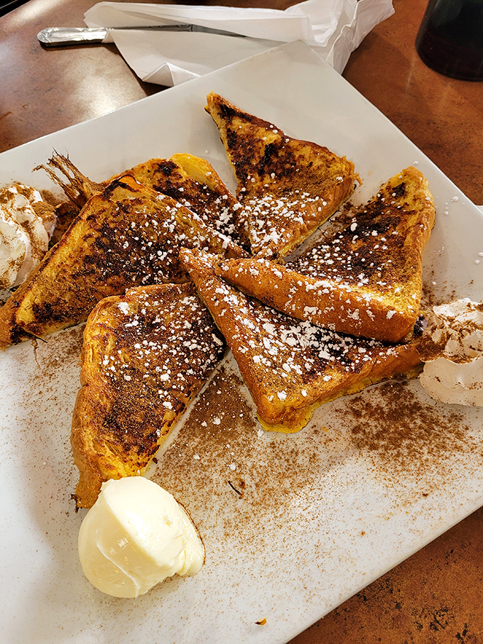 The French toast arrives looking like it just won a beauty pageant &ndash; golden, cinnamon-dusted, and ready for its close-up.