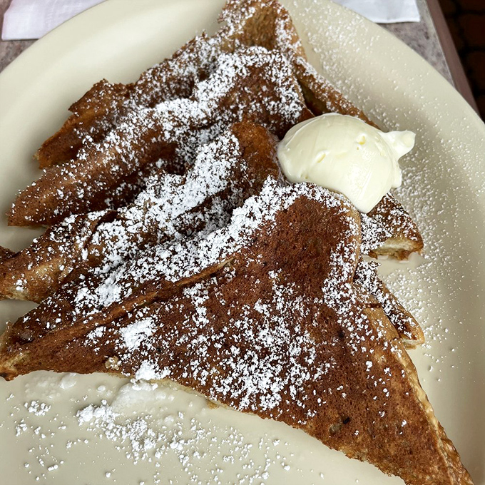 French toast that makes you question why you ever pay $18 for "artisanal" versions elsewhere. That powdered sugar dusting? Pure breakfast magic.