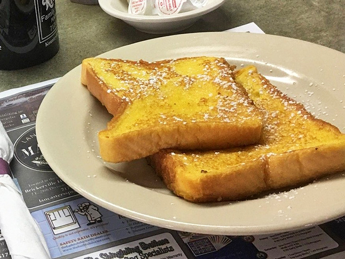 French toast that's achieved that mythical balance – crispy edges, custardy center, and just enough powdered sugar to make breakfast feel like dessert.
