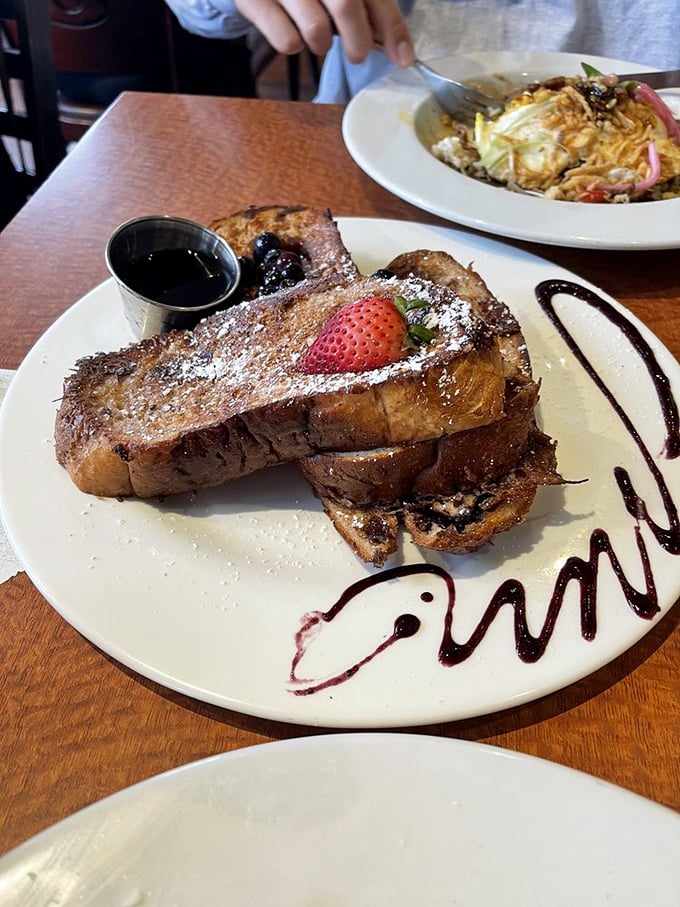 French toast that deserves its own Hollywood star&mdash;thick-cut cinnamon bread transformed into a caramelized masterpiece with artistic chocolate drizzles.