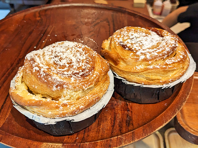 The legendary French toast croissants looking like they just won the pastry Olympics. These spiral-shaped treasures dusted with powdered sugar deserve their own commemorative postage stamp.