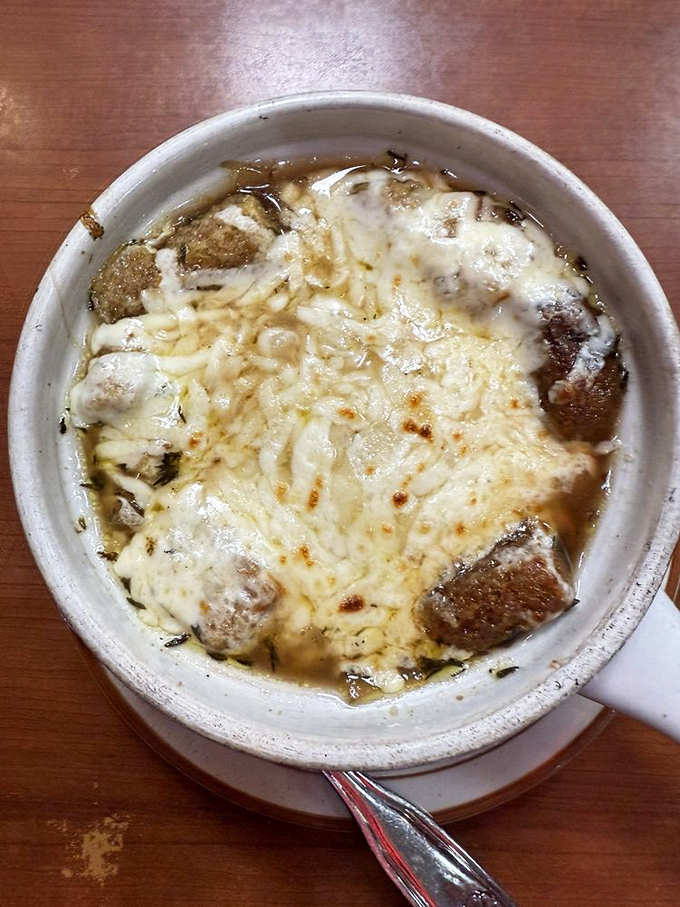 French onion soup done right &ndash; a bubbling cauldron of savory broth where croutons and cheese have united in melty matrimony. Spoon-breaking good.