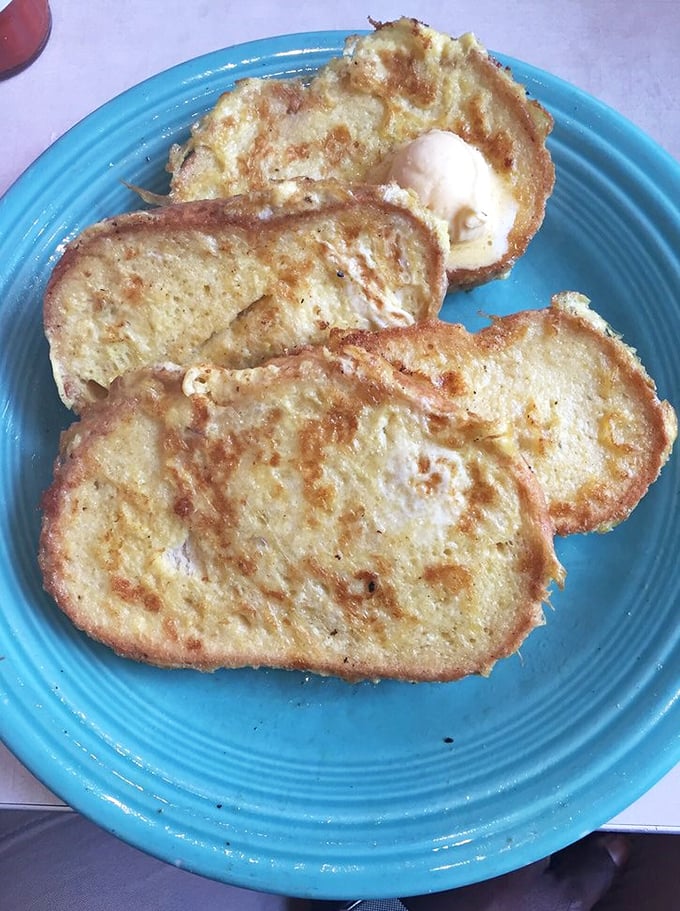 French toast so golden it could win an Olympic medal, dusted with enough powdered sugar to make angels jealous.