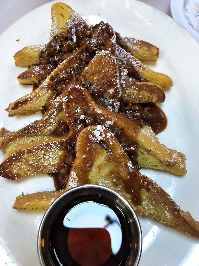 French toast that makes regular bread feel inadequate. That caramelized topping and syrup combo should come with a warning label for deliciousness.