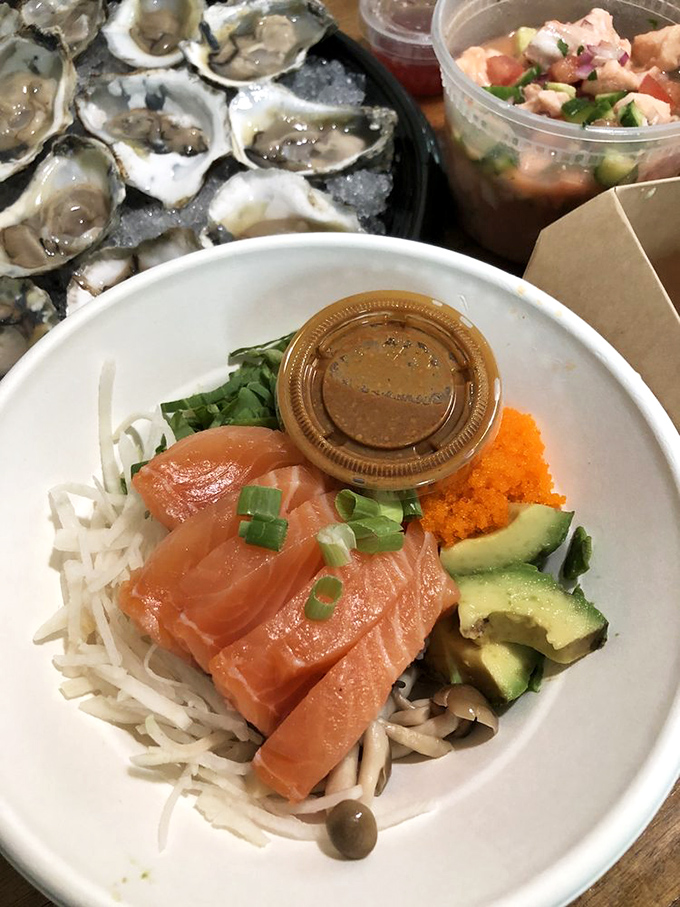 Silky salmon sashimi meets crisp vegetables in a bowl that whispers "Pacific paradise" with every bite. 