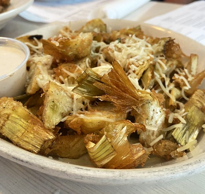 These fried artichoke quarters aren't just appetizers&mdash;they're little golden tickets to happiness, complete with a shower of parmesan that means business.