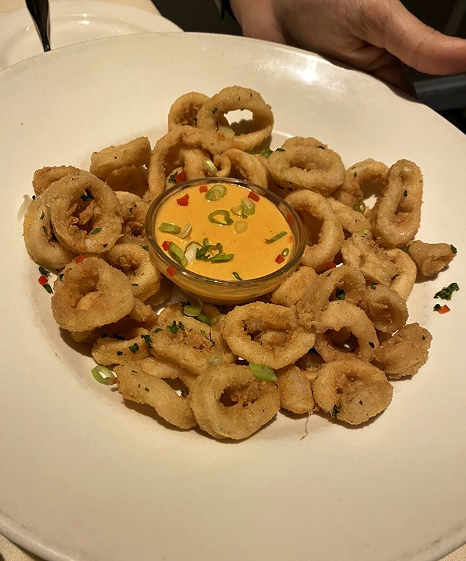Crispy calamari rings surrounding a vibrant dipping sauce&mdash;the seafood equivalent of a perfect halo. Resistance is futile.
