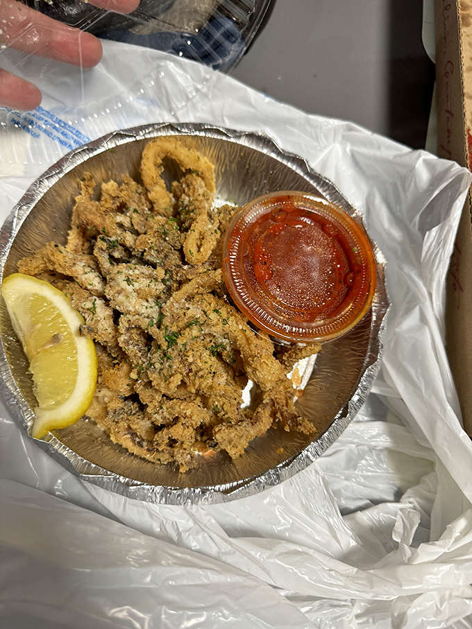 Golden-fried calamari that's crispy where it should be crispy, tender where it should be tender. The lemon isn't a garnish&mdash;it's essential equipment.