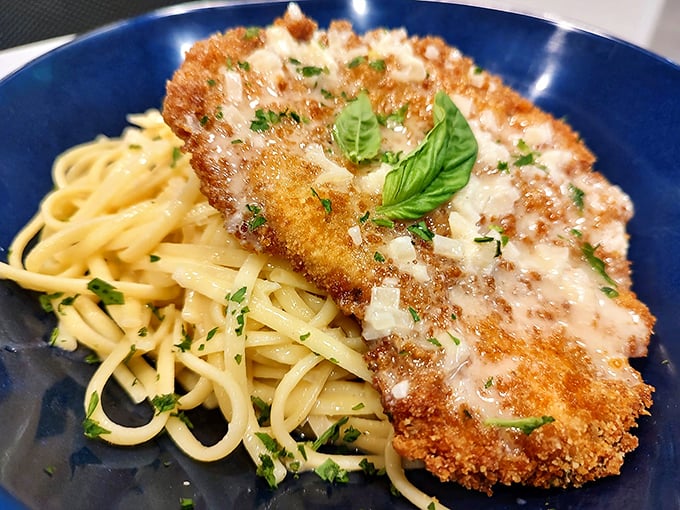Not all heroes wear capes—some wear golden breadcrumbs and rest on a bed of pasta. This crispy chicken cutlet deserves its own theme music.