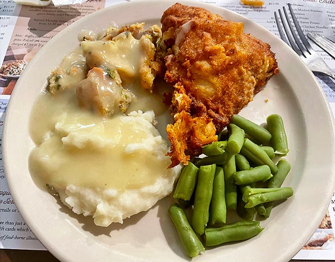 Fried chicken so perfectly golden it deserves its own Instagram account, alongside those legendary mashed potatoes and vibrant green beans.