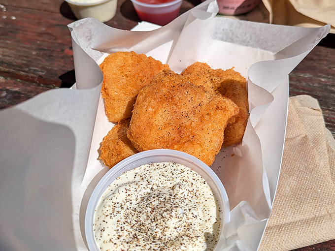 That golden coating shatters like autumn leaves, revealing tender fish that'll make you forget all other seafood.