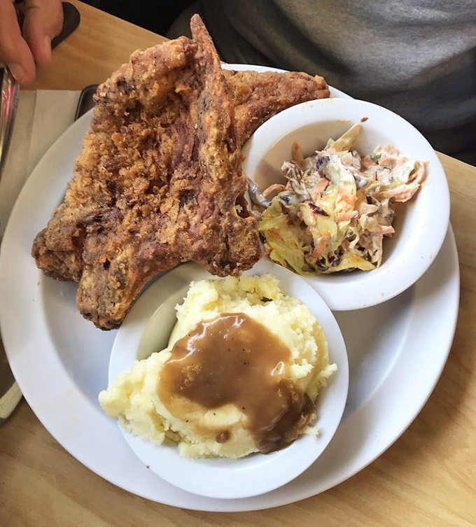 That pork chop isn't just fried, it's transformed into something transcendent. The sides aren't afterthoughts; they're co-stars in this delicious production.