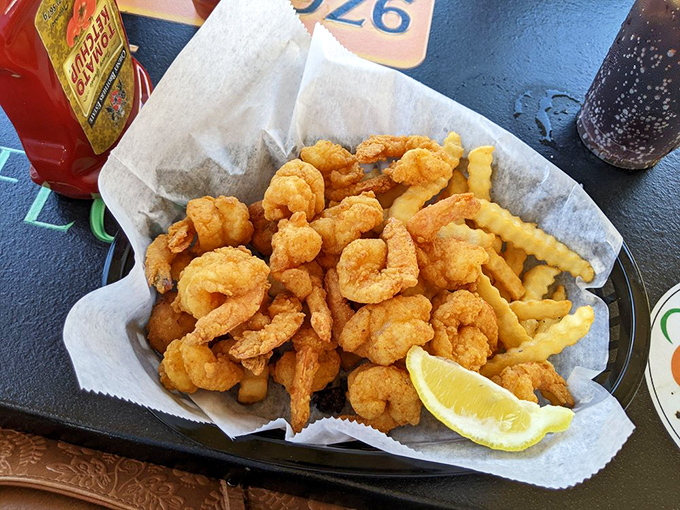 The legendary fried shrimp in their natural habitat – nestled among crinkle-cut fries with a lemon slice standing by for that perfect squeeze.
