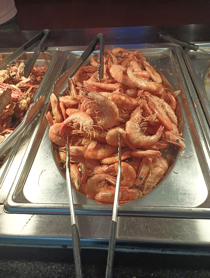 The shrimp buffet tray—where these little pink treasures huddle together like synchronized swimmers waiting for you to give them perfect 10s with your taste buds.