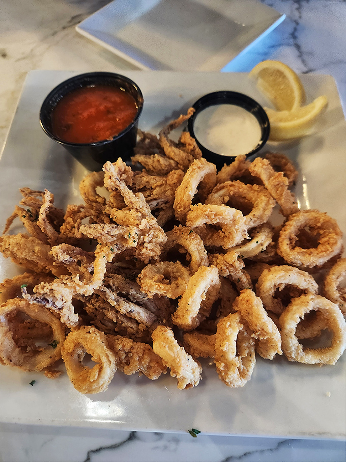 Fried calamari that's actually tender inside that golden crust? It's not a myth &ndash; it exists here, with dipping sauces that deserve their own fan club.