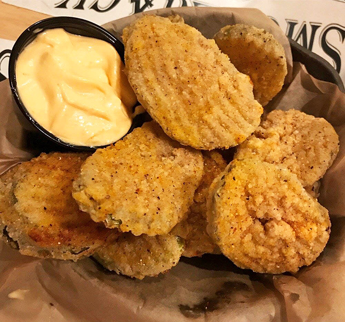 Fried pickles: the unsung heroes of Southern appetizers. Crispy, tangy discs of joy served with a dipping sauce that demands double-dipping.