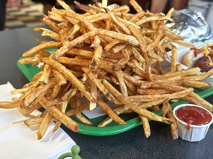 These aren't your average fries—they're golden, hand-cut potato perfection with a crispness that sings and a fluffiness that whispers sweet nothings to your soul.