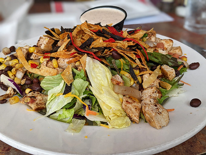 A salad that defies the "rabbit food" stereotype &ndash; loaded with grilled chicken, crispy tortilla strips, and enough fresh vegetables to silence your doctor temporarily.