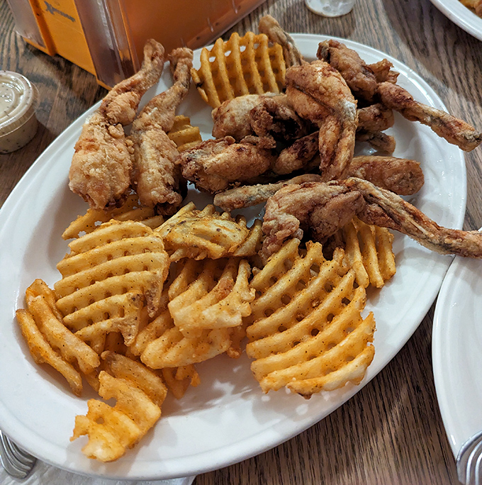 Crispy on the outside, tender within – these golden-fried frog legs with waffle fries might just make you jump for joy.