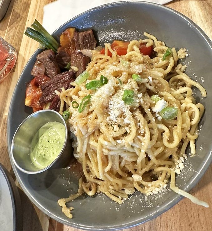 These aren't your college dorm room noodles. Garlic-infused, perfectly chewy, and topped with just enough green onion to make your taste buds do a happy dance.
