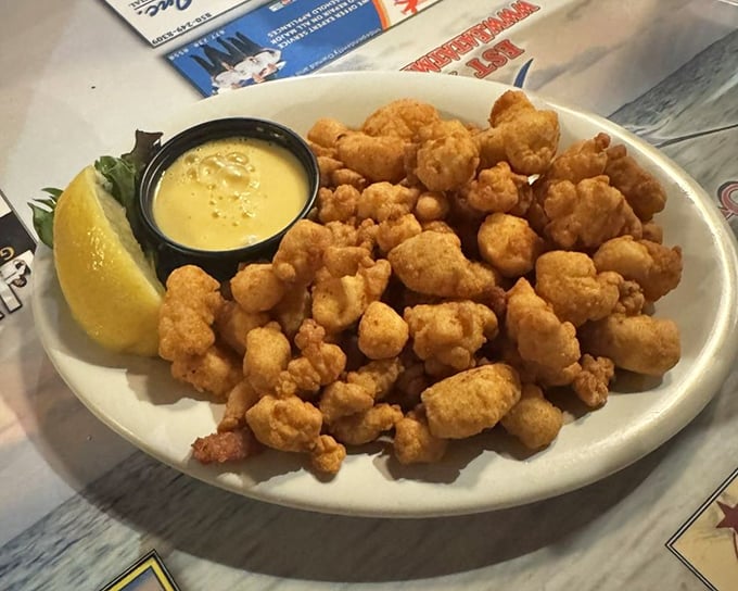 Golden nuggets of fried gator bites with honey mustard dipping sauce—proof that sometimes the predator becomes the most delicious prey.