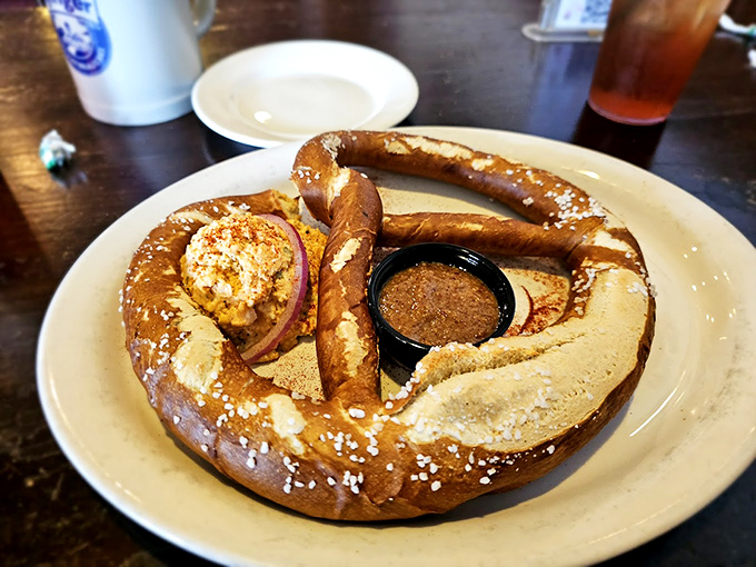 The pretzel that ate Manhattan! This doughy behemoth arrives with mustard and obatzda cheese spread, demanding to be photographed before devoured.
