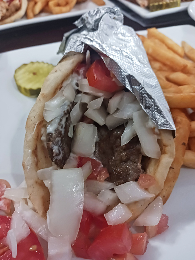 The gyro—where thinly sliced meat, fresh veggies, and a pita come together in a foil-wrapped package of Mediterranean joy.