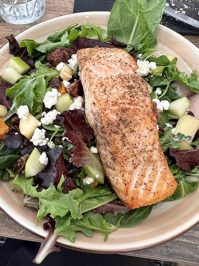 This salmon salad could convert even the most dedicated carnivore. The perfectly seared fish perches atop a garden of greens like it's auditioning for a magazine cover.