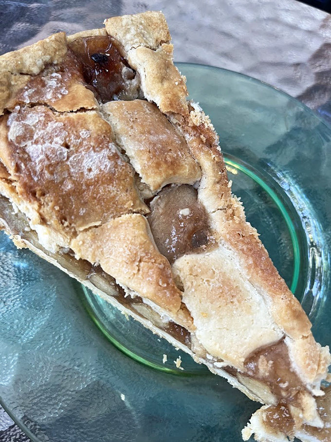 This isn't just apple pie—it's edible architecture with a golden-brown lattice roof sheltering treasure that would make pirates change careers.