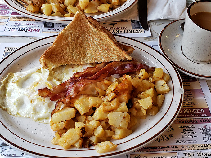 Golden home fries and perfectly cooked eggs prove that simple ingredients create the most satisfying symphonies.