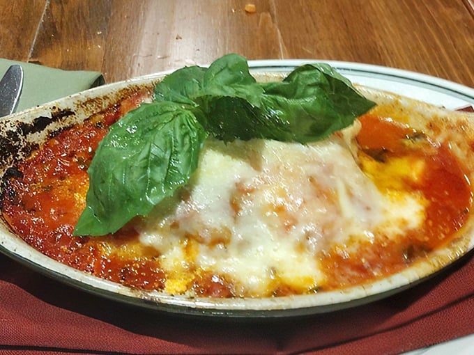 Lasagna that would make any Italian grandmother nod in approval. The basil garnish isn't just pretty&mdash;it's a promise of the flavor explosion waiting beneath.