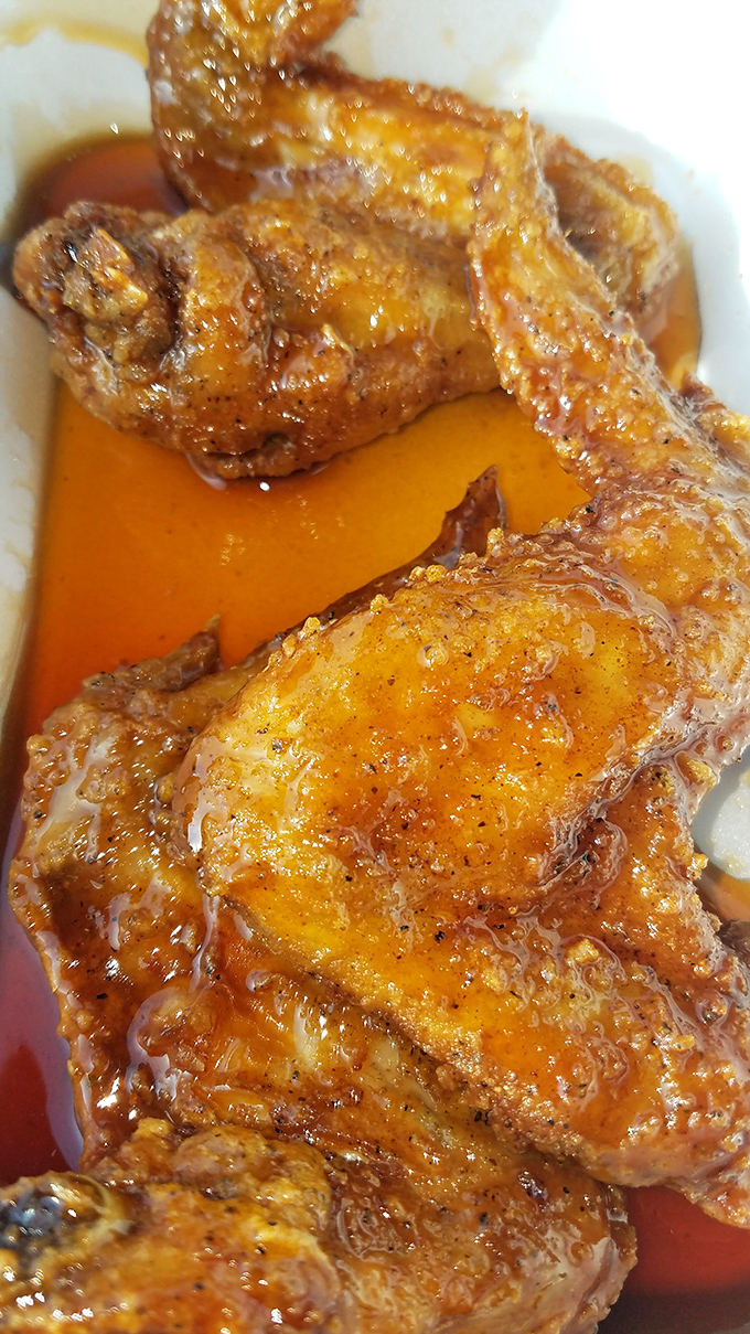 Golden-hued wings bathing in their own magnificent sauce. If Midas was a chef, this is what he'd create instead of gold.