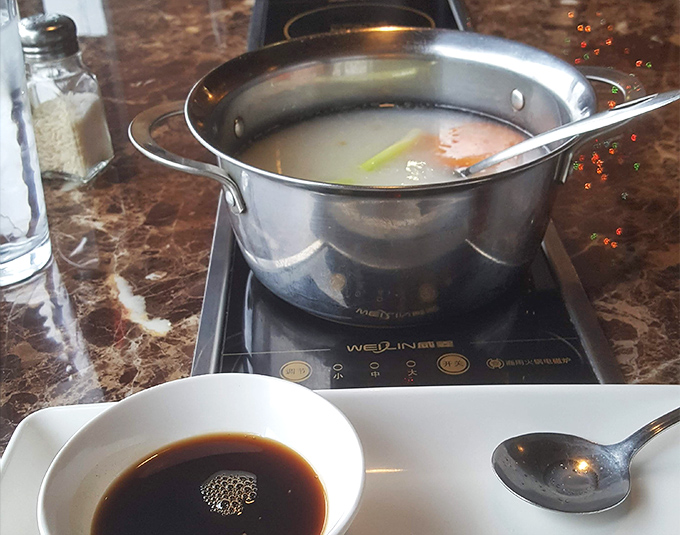 The hot pot simmers with promise, a cauldron of flavor waiting to transform fresh seafood into something magical. Patience rewarded.