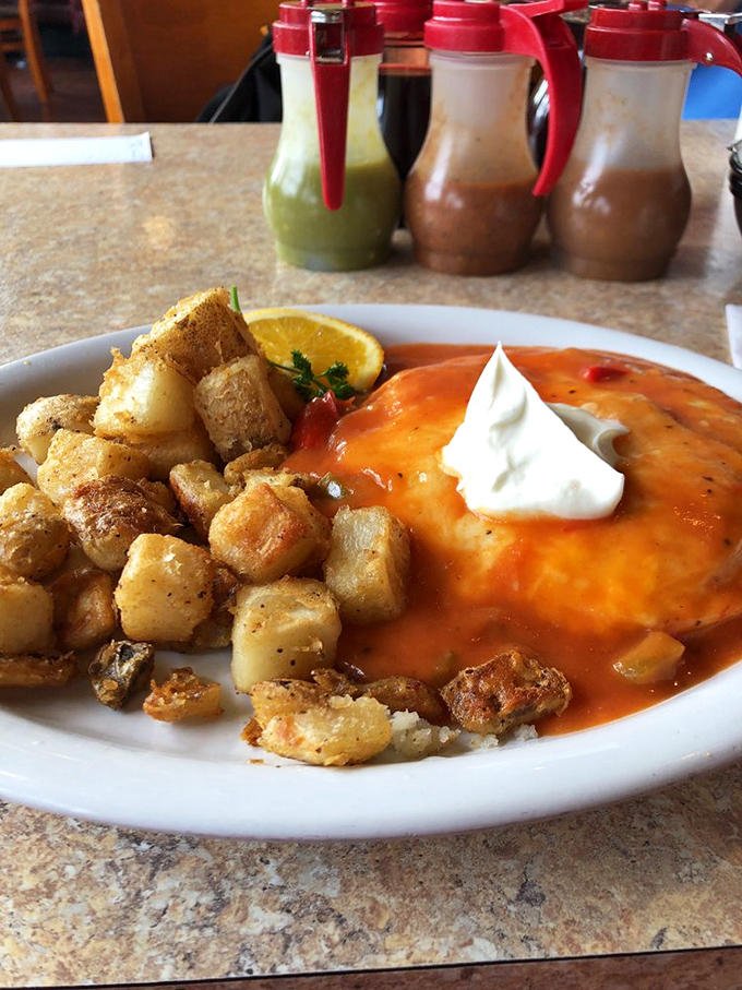 This isn't just huevos rancheros&mdash;it's breakfast wearing a party hat. Vibrant sauce, crispy potatoes, and that dollop of sour cream that says "Good morning, gorgeous."