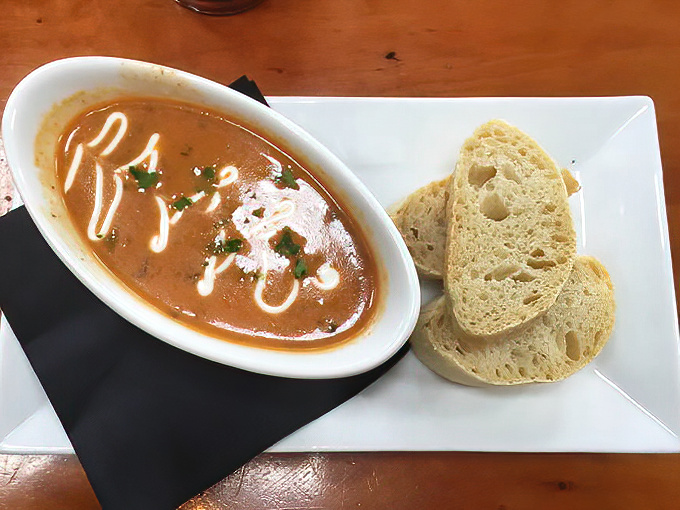 A bowl of Hungarian mushroom soup that would make your grandmother question her secret recipe. The bread's just showing off. 