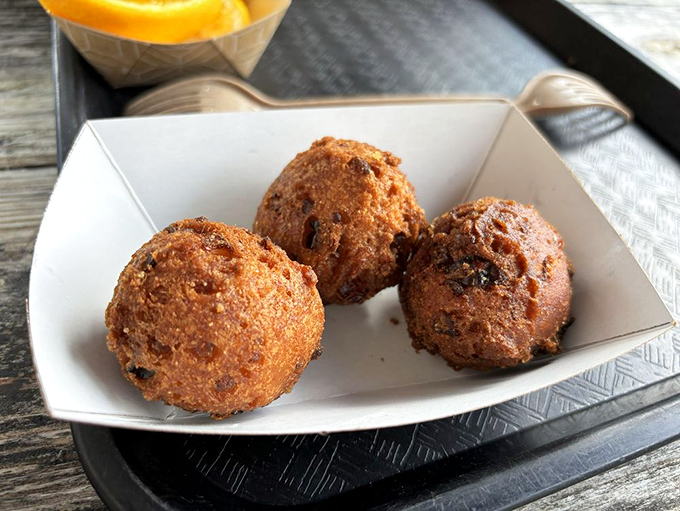 These hush puppies aren't keeping any secrets &ndash; crispy exterior, fluffy interior, and enough flavor to make you contemplate ordering a second round immediately.