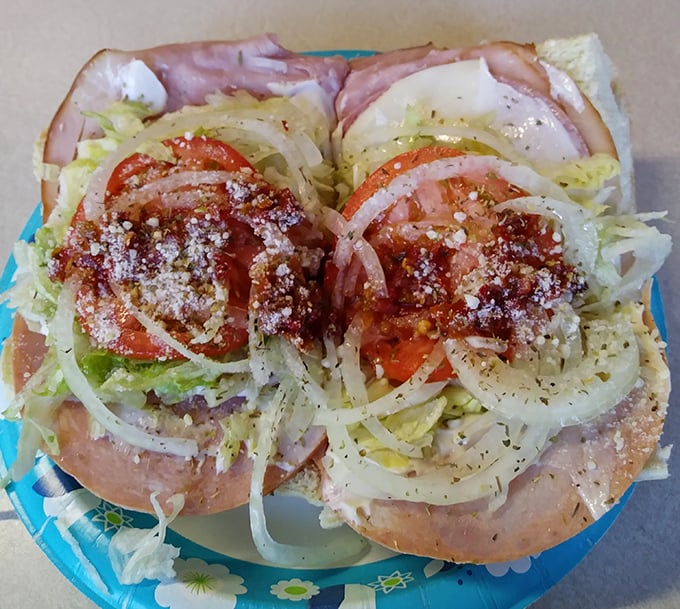 Fresh ingredients stacked with precision—this Italian hoagie is architectural perfection. The sprinkle of oregano and oil is the chef's kiss.