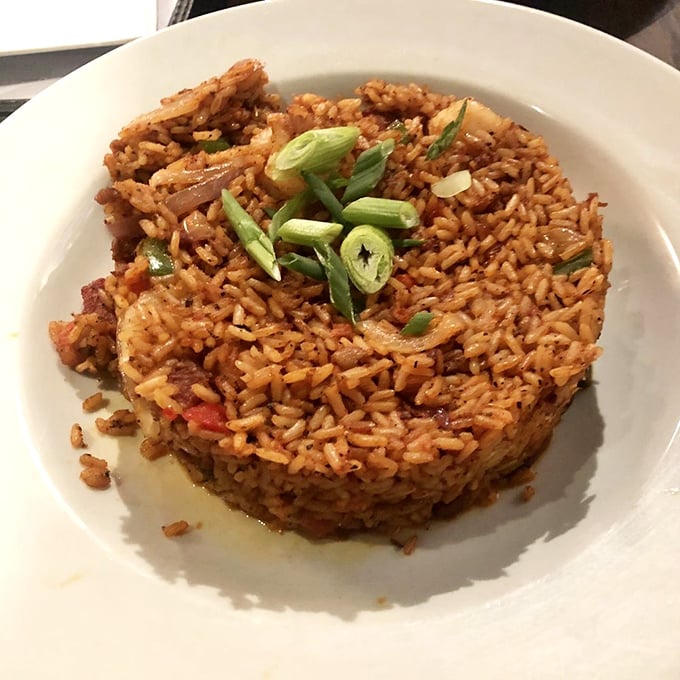 Charleston red rice, shaped into a perfect dome and crowned with scallions&mdash;proof that side dishes can steal the spotlight with enough personality.