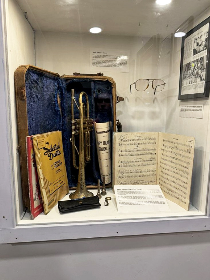 A haunting display featuring a trumpet and personal effects that tell stories far more complex than the simple instruments themselves suggest.