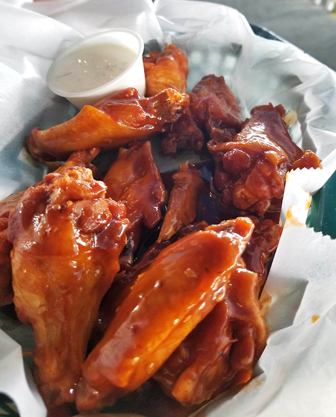 Wings so glossy they could be in a food magazine, glazed with sauce that walks that perfect tightrope between sweet and heat.