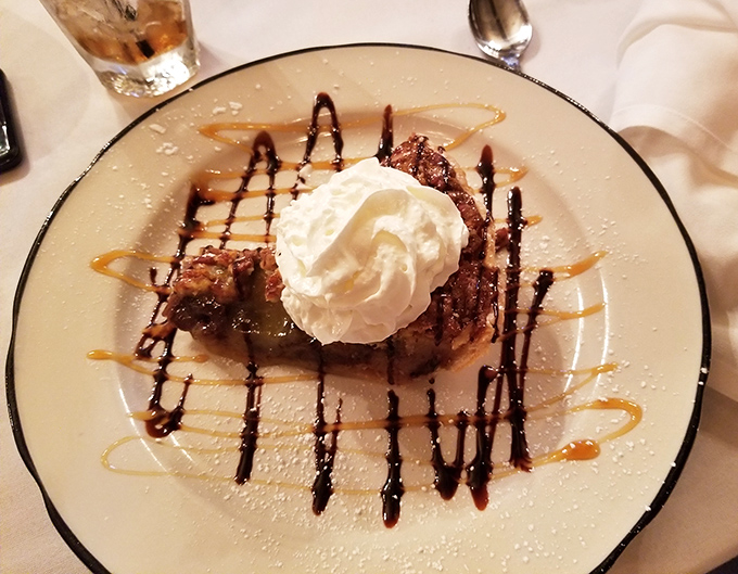 Kentucky Derby Pie arrives like a sweet victory lap, complete with artistic chocolate drizzles.